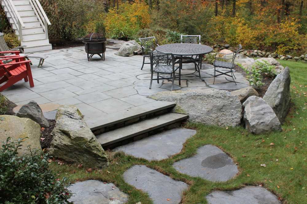 This random rectangular bluestone patio overlooks a peaceful woodland ...